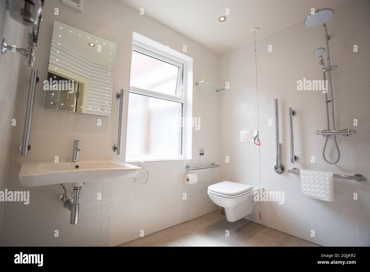 Simple hotel bathroom interior with white walls with toilet, shower ...