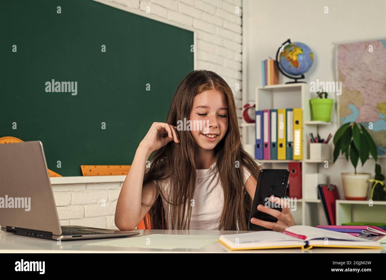 girl in classroom school with smartphone, online education Stock Photo ...