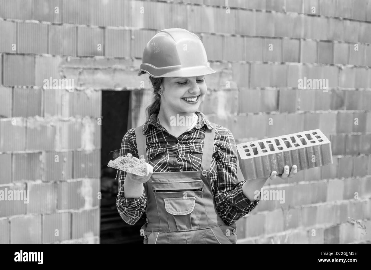exploring tools. future engineer. happy kid use brick for renovation ...