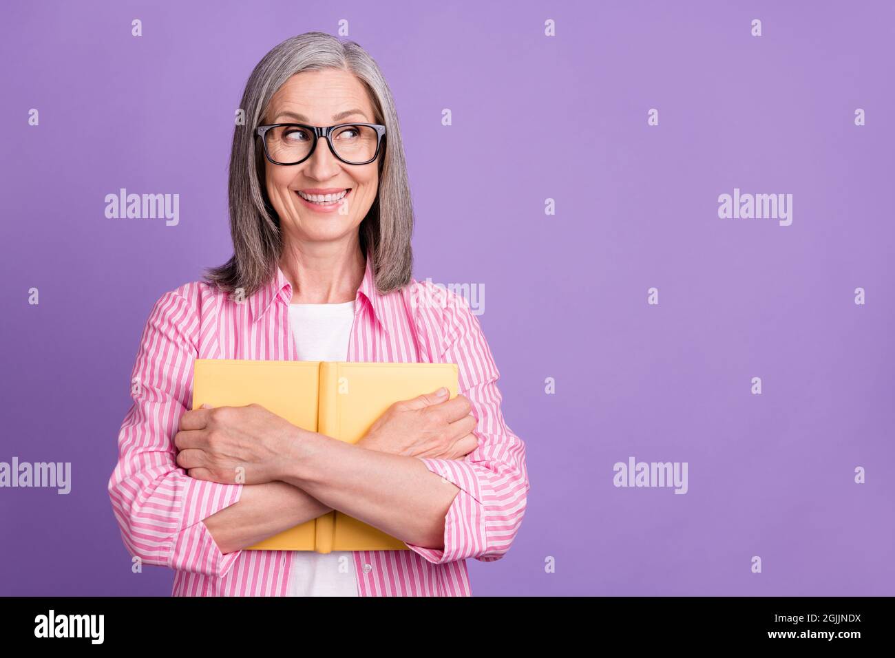 Photo of aged woman happy positive smile hug cuddle book literature ...
