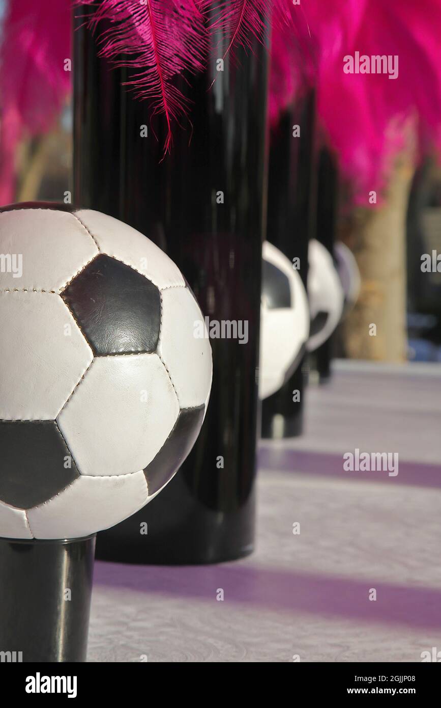 Vertical closeup of the football balls on the black pillars Stock Photo ...