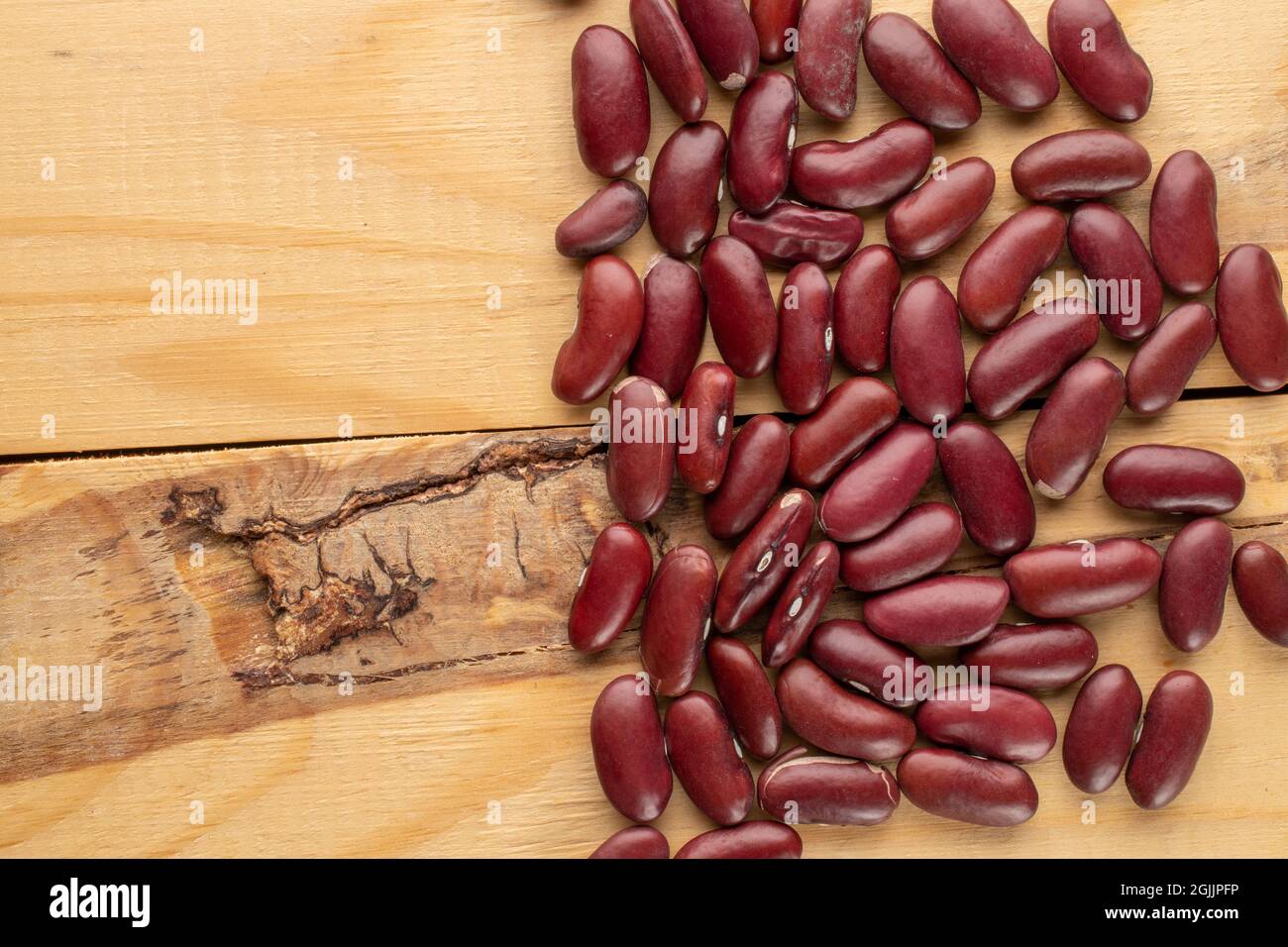 Not cooked organic, red beans, close-up, on a wooden table, top view ...