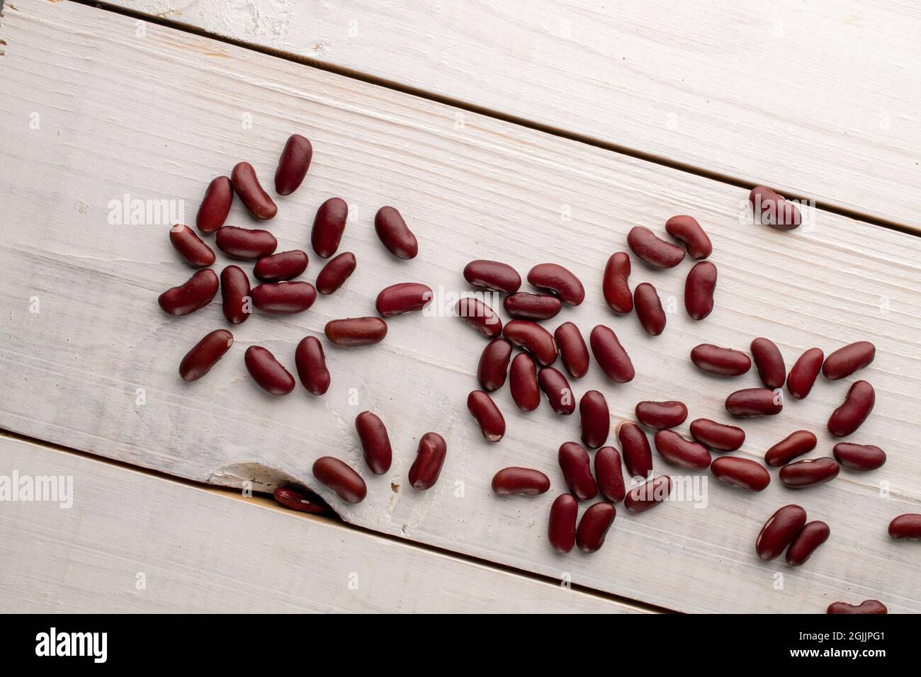 Not cooked organic, red beans, close-up, on a wooden table, top view ...