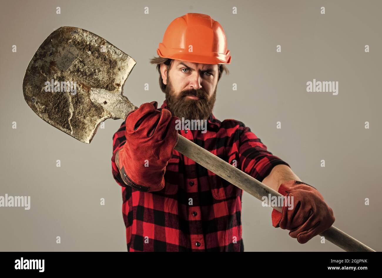 handsome bearded guy with beard and moustache hold shovel, laborer ...