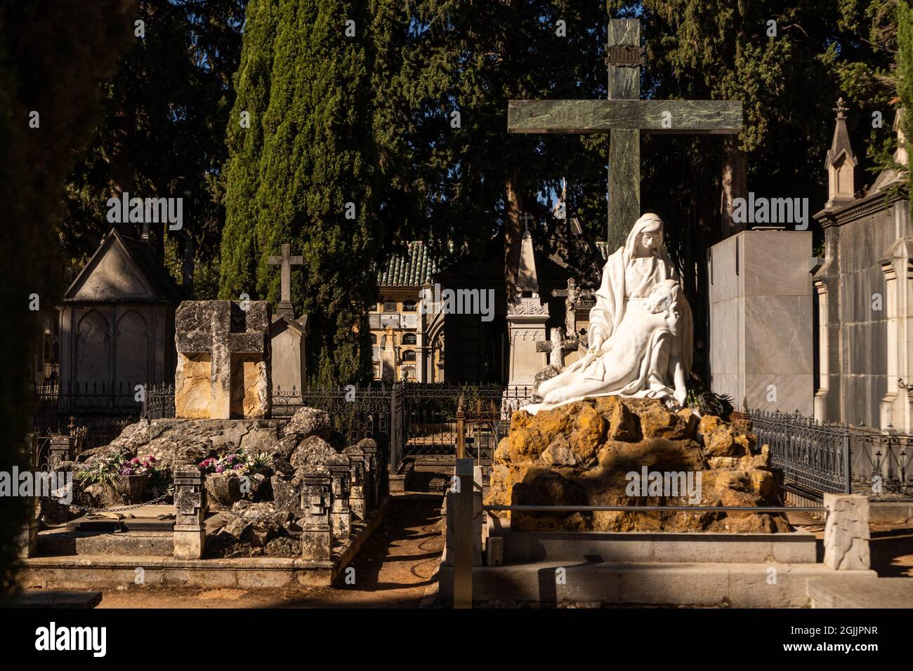 View of graves in a quiet and empty old cemetery during the day Stock ...