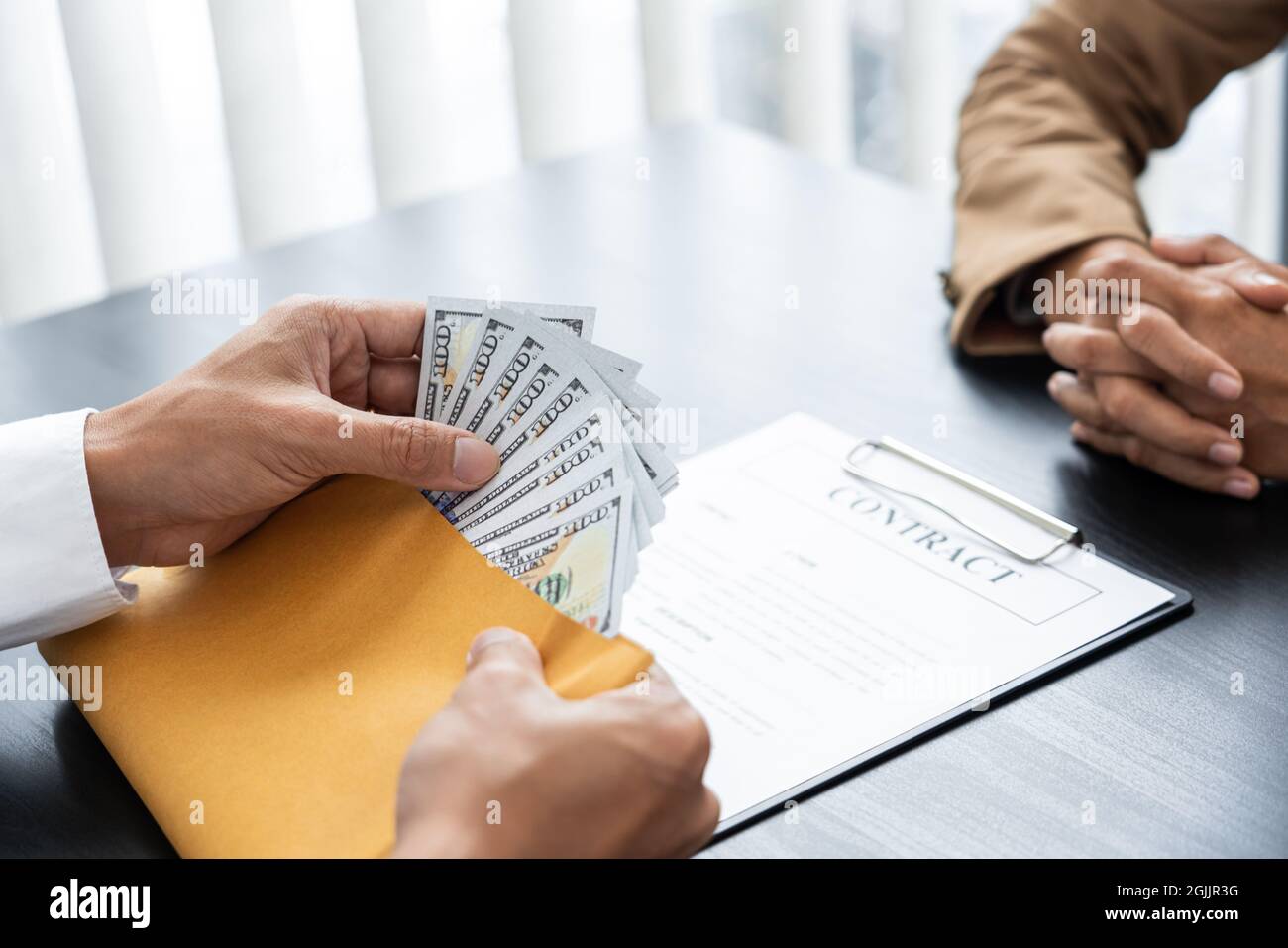 two hands passing bills making agreement to initiate the new business ...