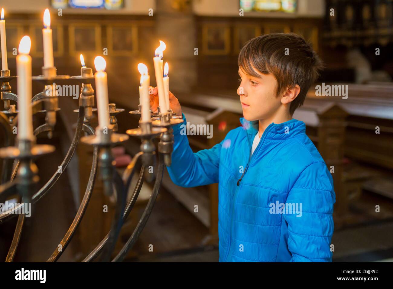 Little child, boy, praying in church, cathedrale in Stockholm, Sweden ...