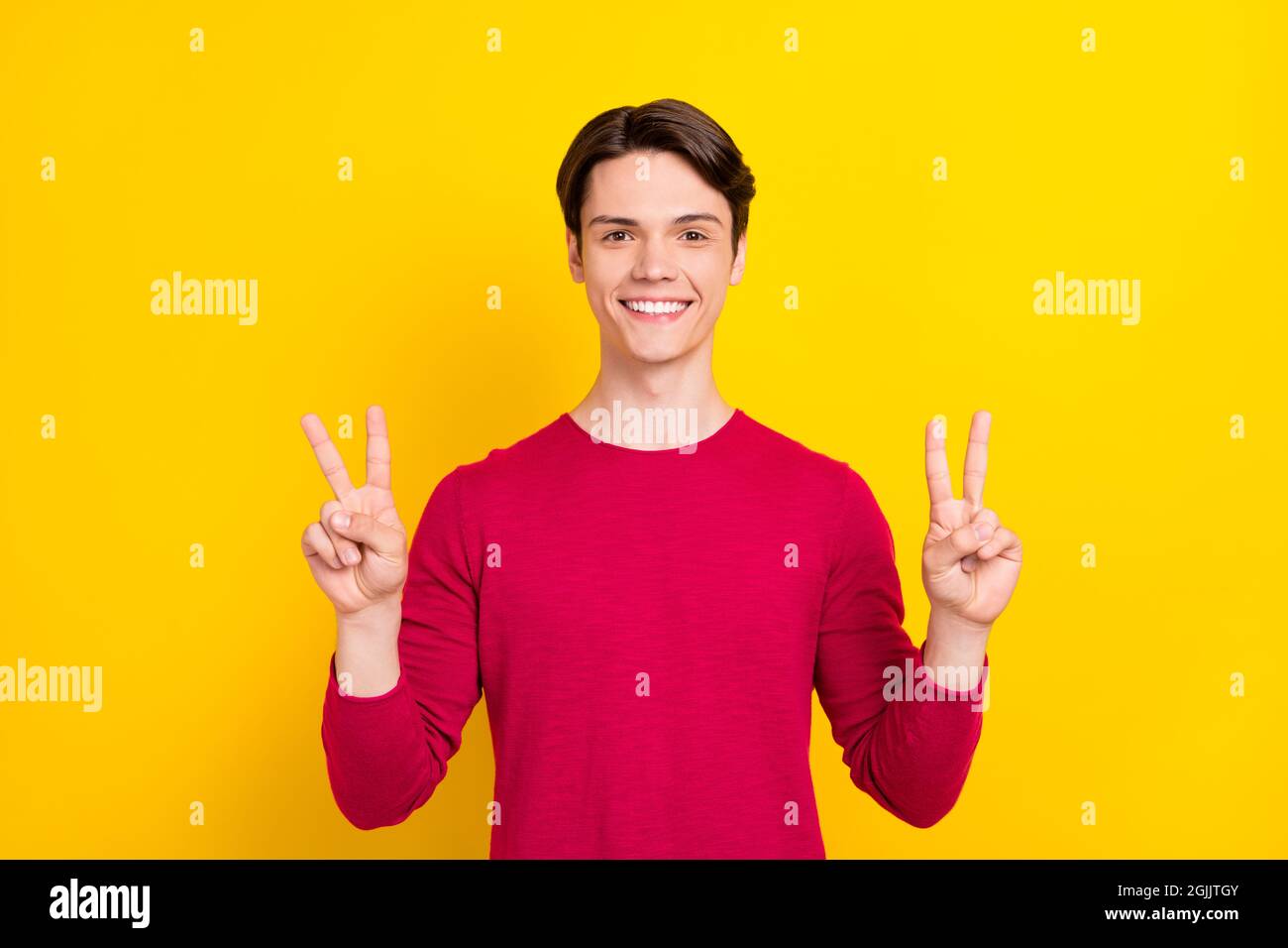 Photo of sweet pretty young gentleman wear red sweater showing two v ...