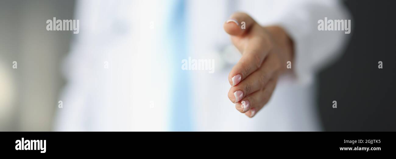 Doctor holds out his hand for handshake Stock Photo - Alamy