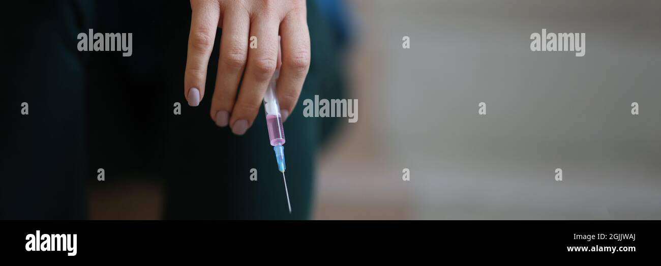 In female hand syringe with needle closeup Stock Photo - Alamy
