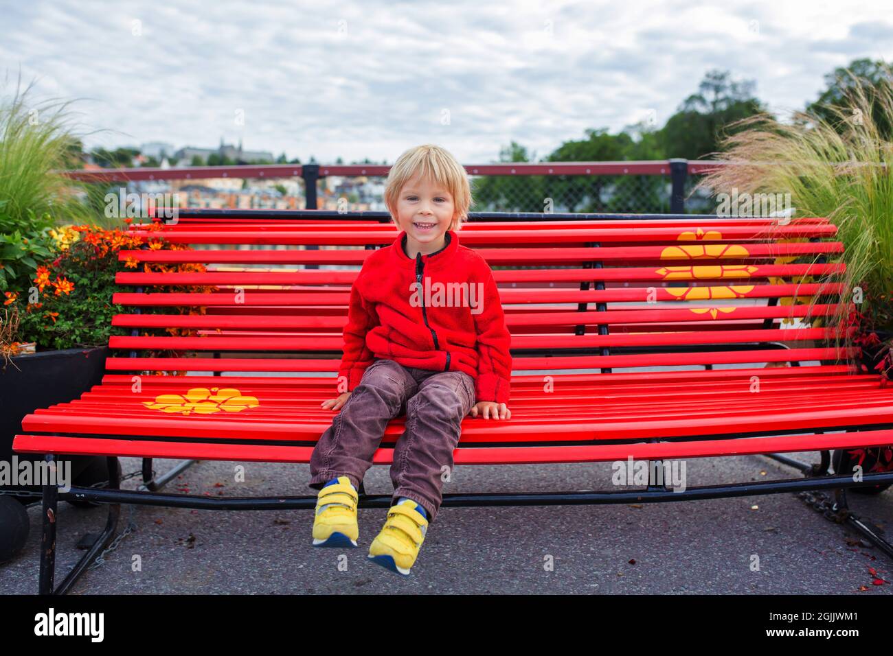 Cute child, boy, visiting Trondheim, Norway during the summer, enjoying ...
