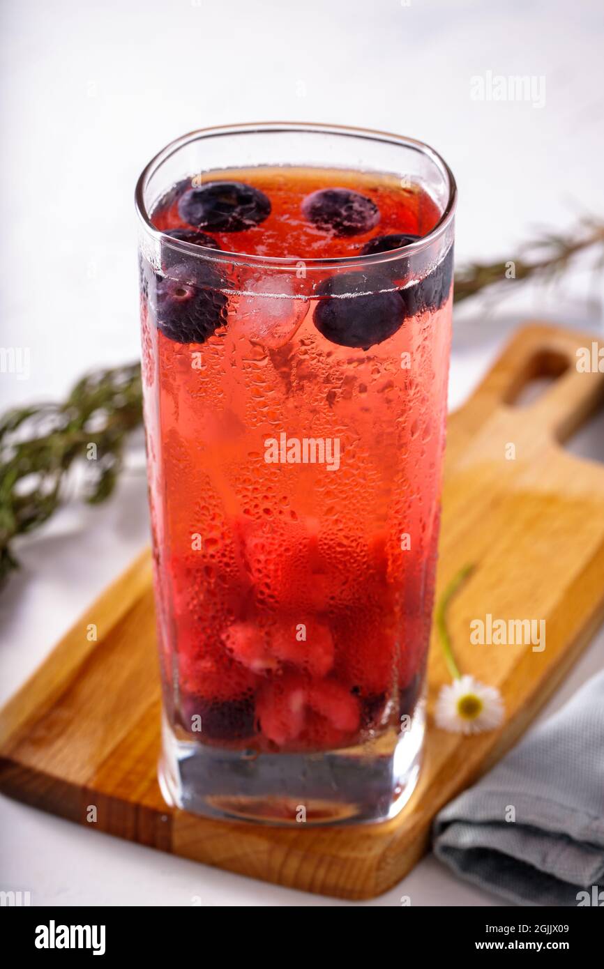 Cold tall glass with red fruits juice Stock Photo - Alamy
