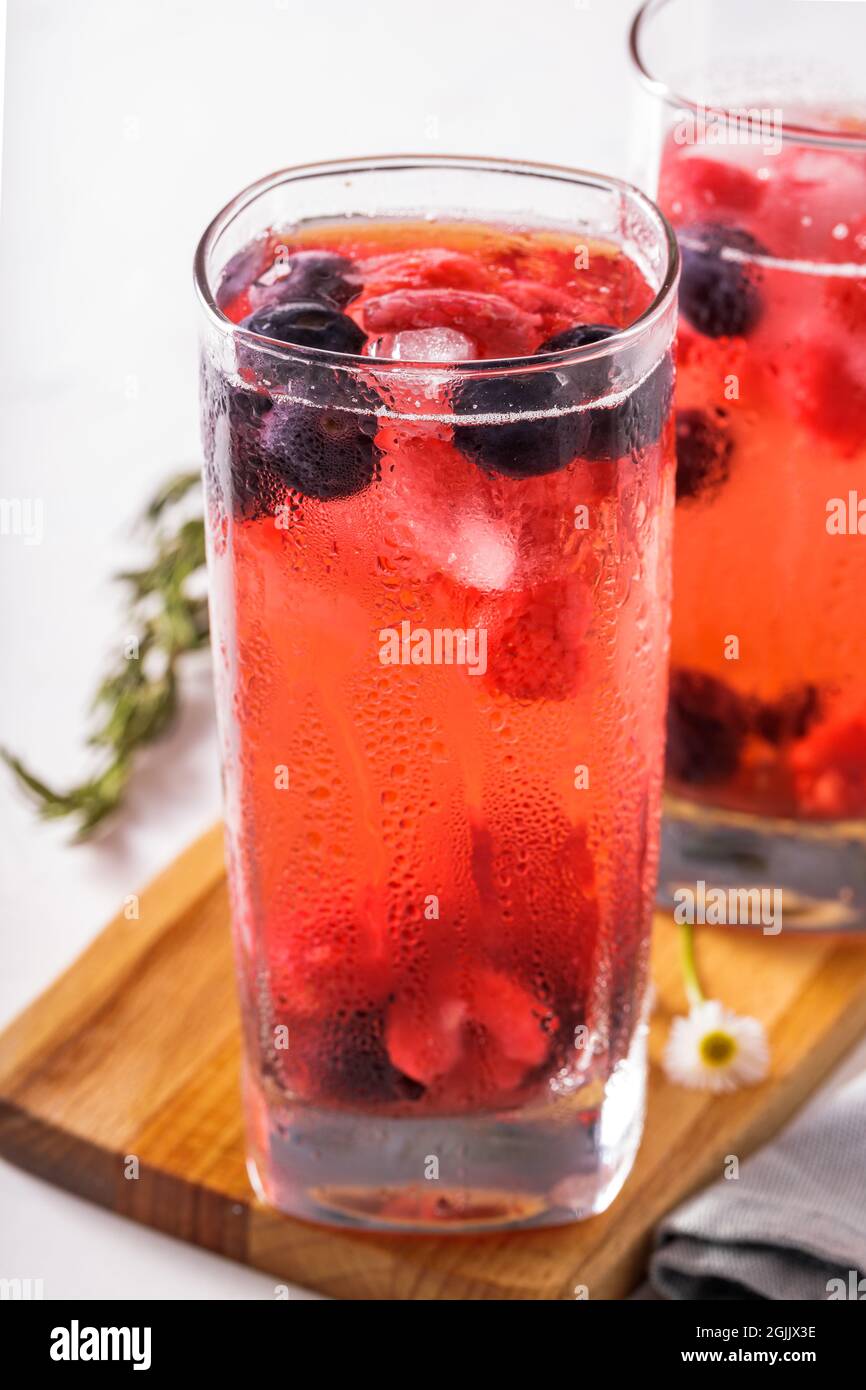 Two cold tall glasses with red fruits juice Stock Photo - Alamy
