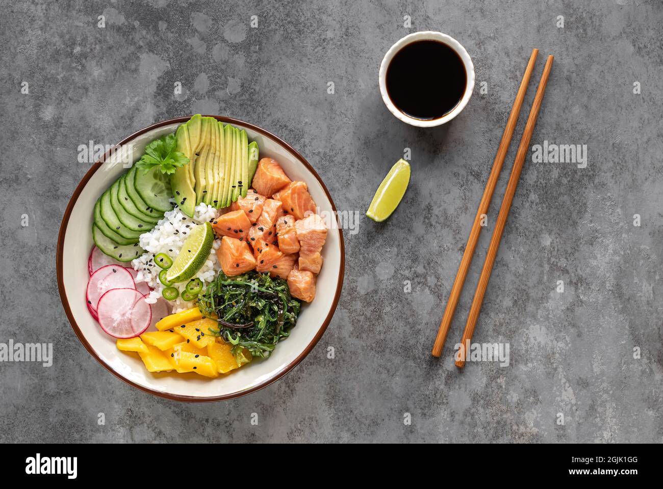 Hawaiian salmon fish poke bowl with rice, mango, radish, cucumber ...