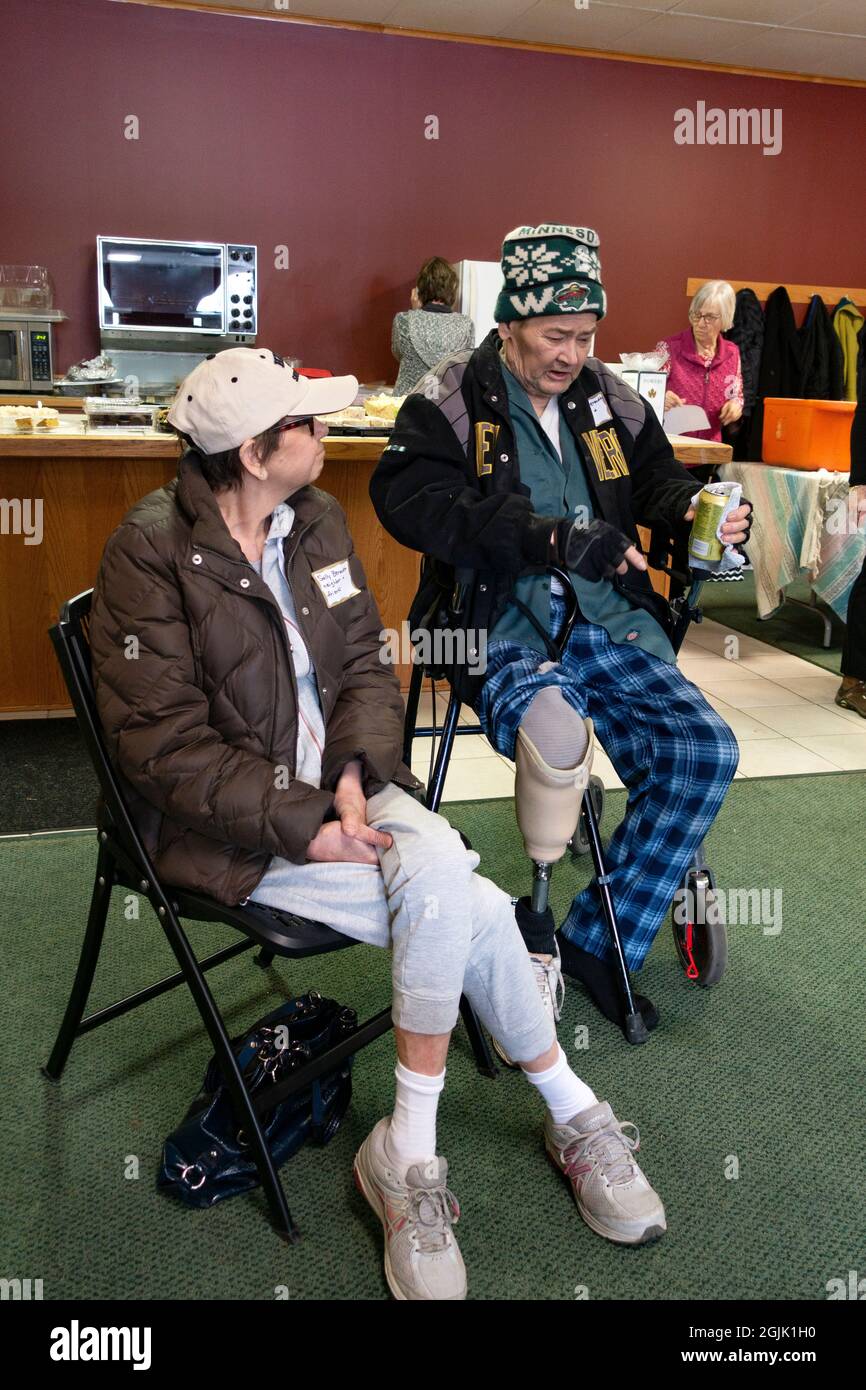 Couple at a gathering with the man disabled having an artificial leg ...