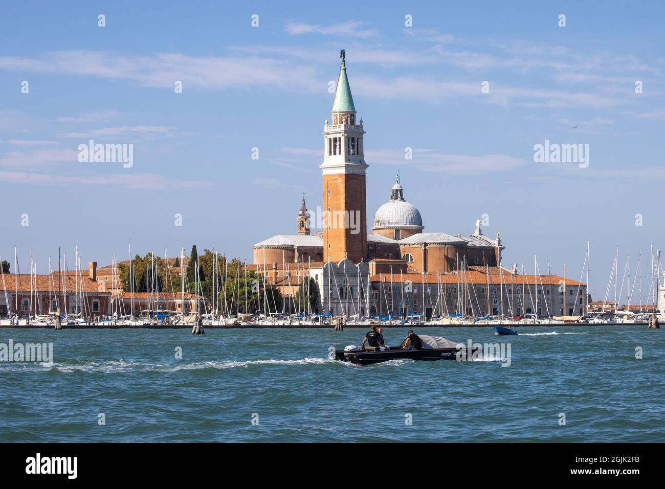 A boat passes the island of San Giorgio Maggiore which is opposite the ...
