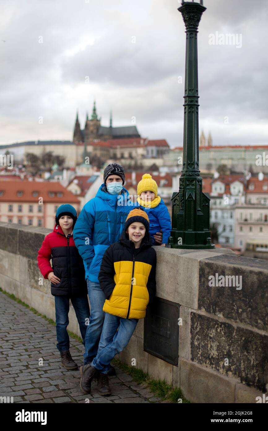Happy family with children on a Charles bridge wintertime in Prague ...