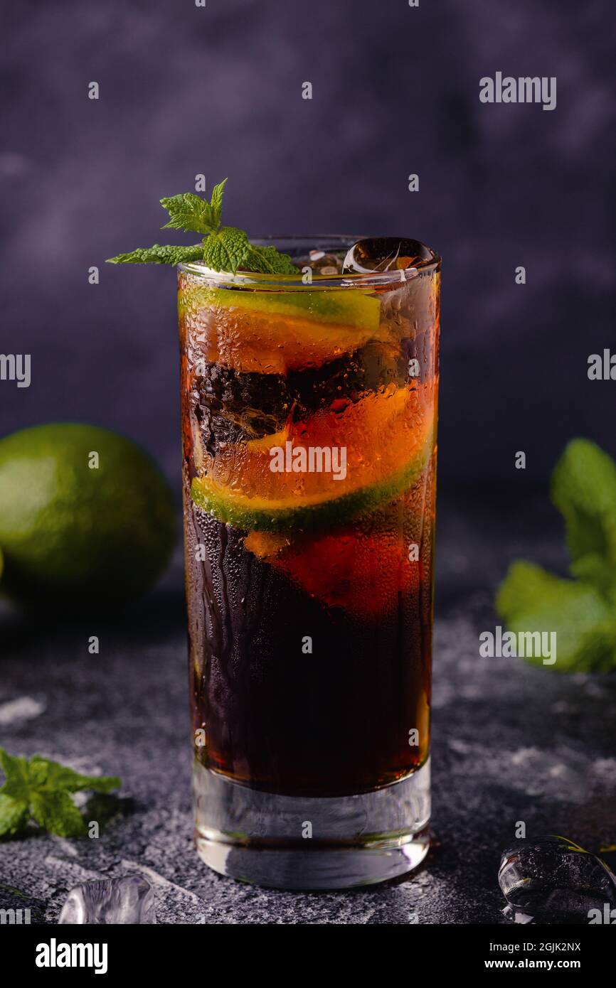 Rum and Cola cocktail Cuba Libre with lime and ice Stock Photo - Alamy