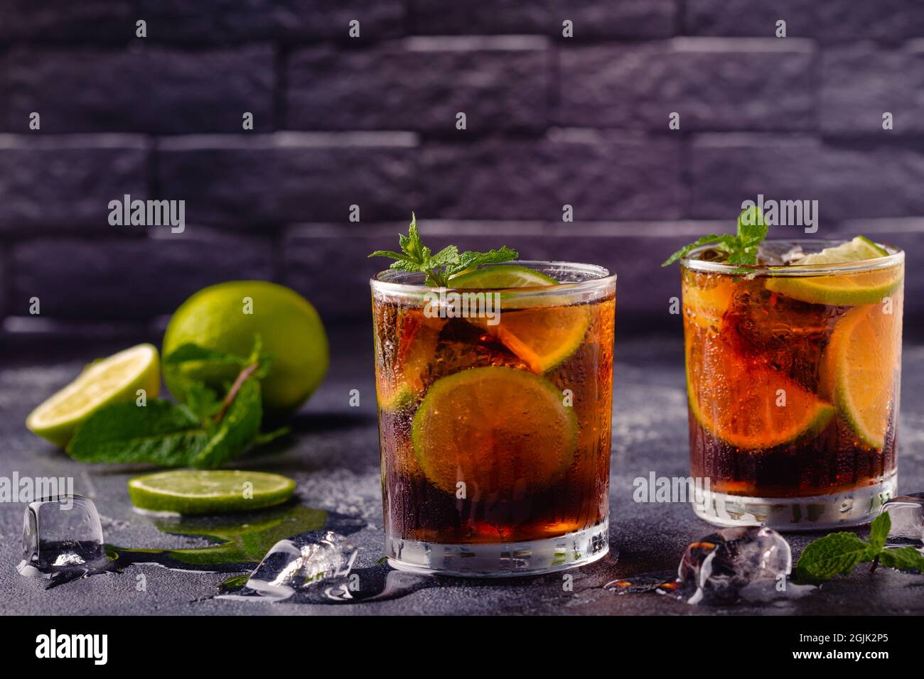 Rum and Cola cocktail Cuba Libre with lime and ice Stock Photo - Alamy