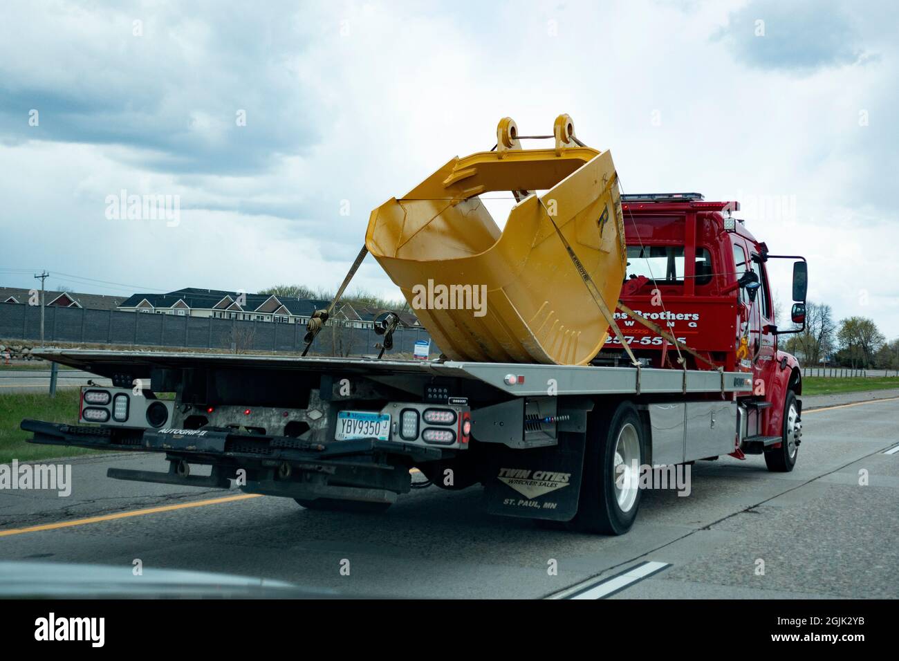 Truck transporting on the highway a large scoop from a piece of ...