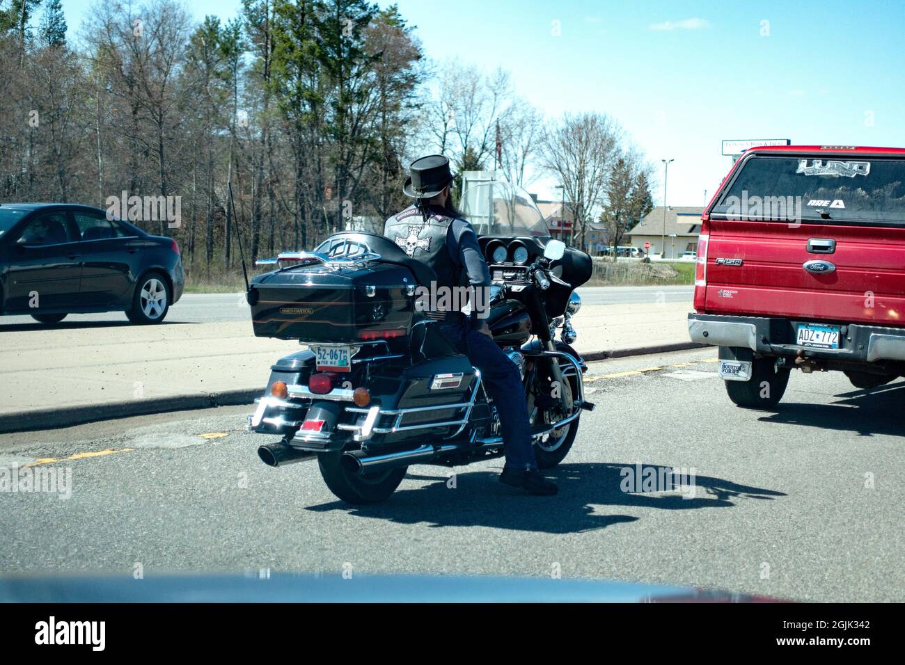 Traveler riding his motorcycle wearing a formal top hat. Nisswa ...