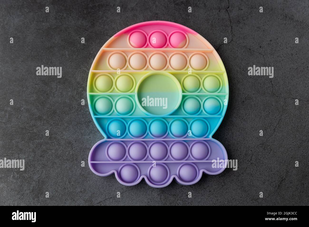 Pop it octopus shape on dark background Stock Photo - Alamy