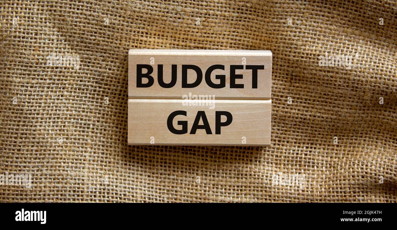 Budget gap symbol. Wooden blocks with words 'Budget gap'. Beautiful ...