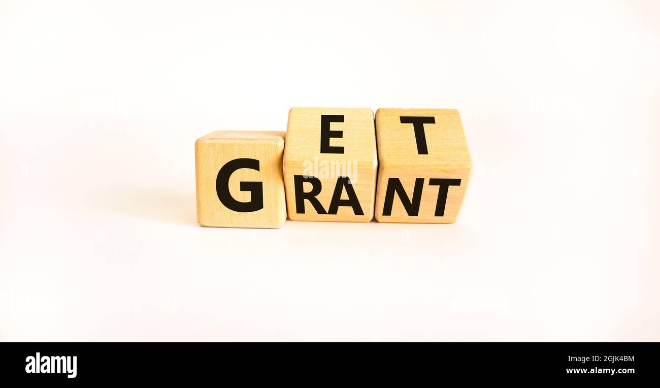 Get grant symbol. Turned wooden cubes with concept words 'Get grant' on ...