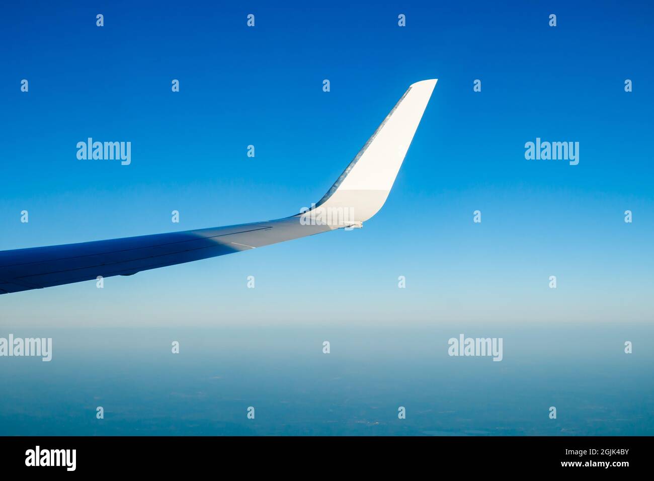 Plain wing over blue sky. Flight from Amsterdam to Helsinki Stock Photo ...