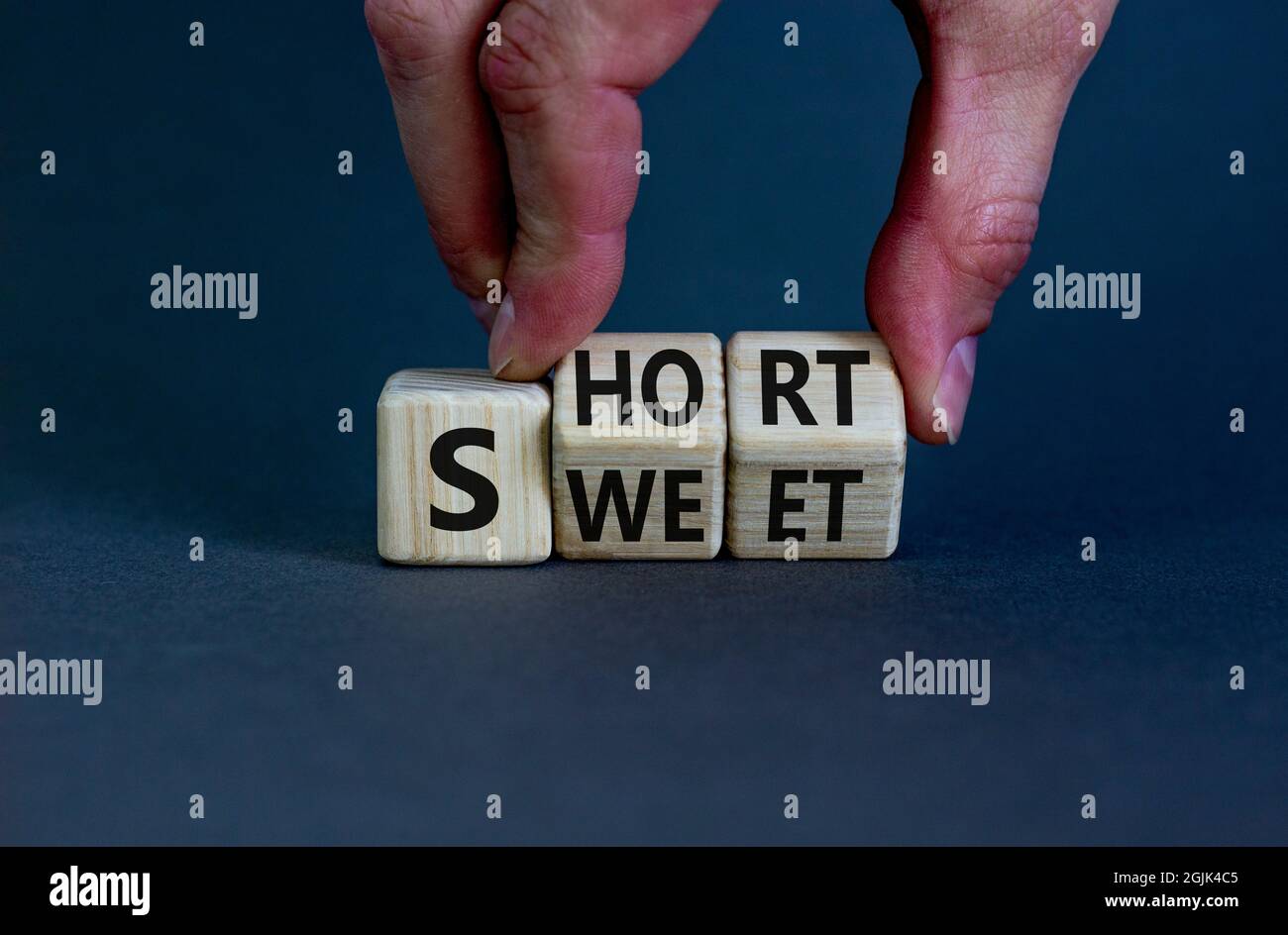 Short and sweet symbol. Businessman turns wooden cubes and changes the ...