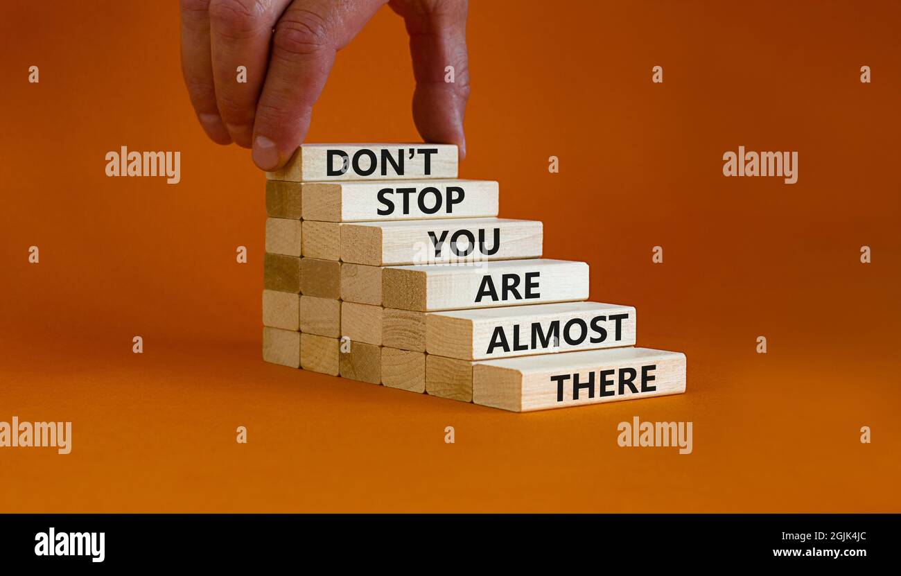 You are almost there symbol. Wooden blocks with words 'dont stop you ...
