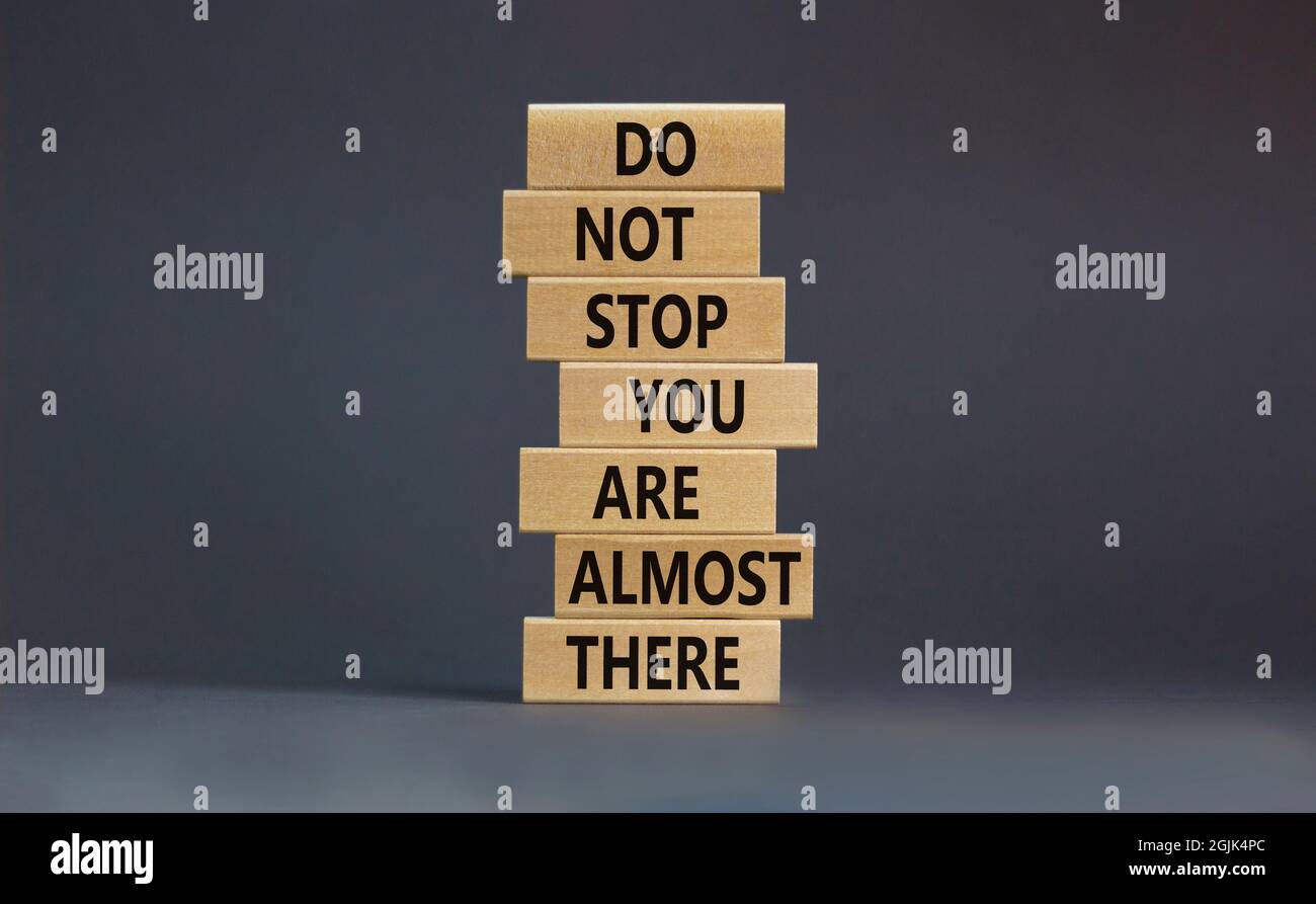 You are almost there symbol. Wooden blocks with words 'do not stop you ...