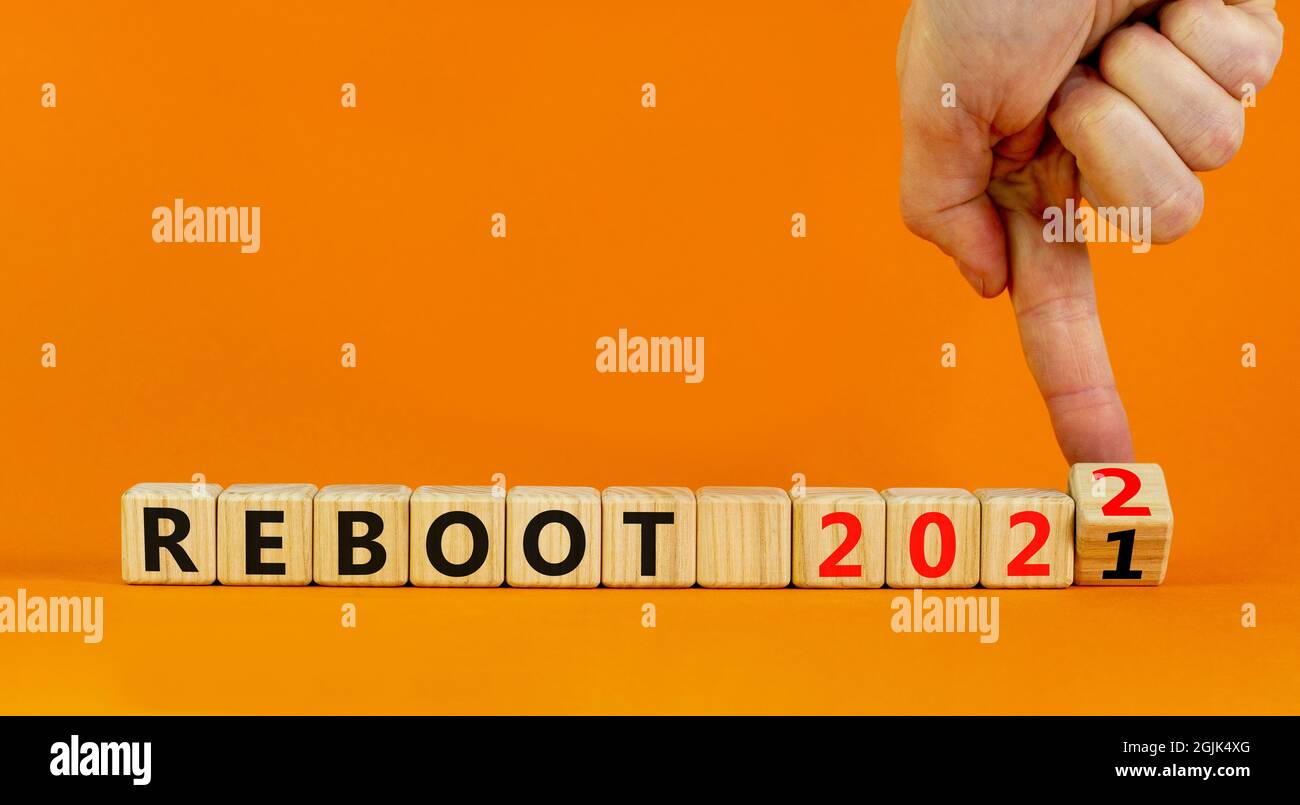 2022 reboot new year symbol. Businessman turns wooden cubes and changes ...
