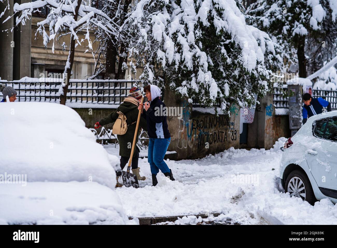 Snow removal, worker cleaning the snowy road in Bucharest, Romania ...