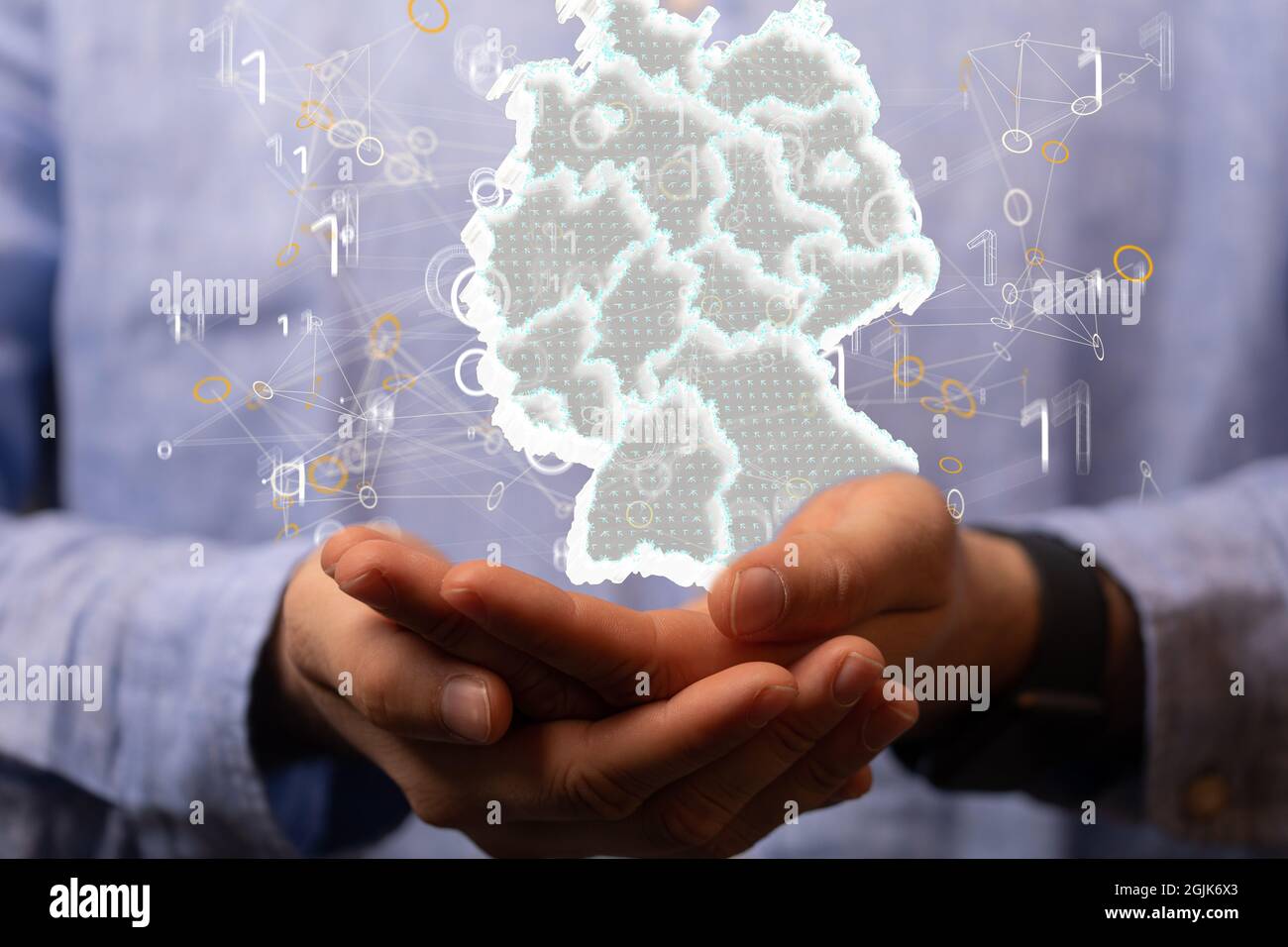Shot of the Germany map concept surrounded by bits over human hands ...