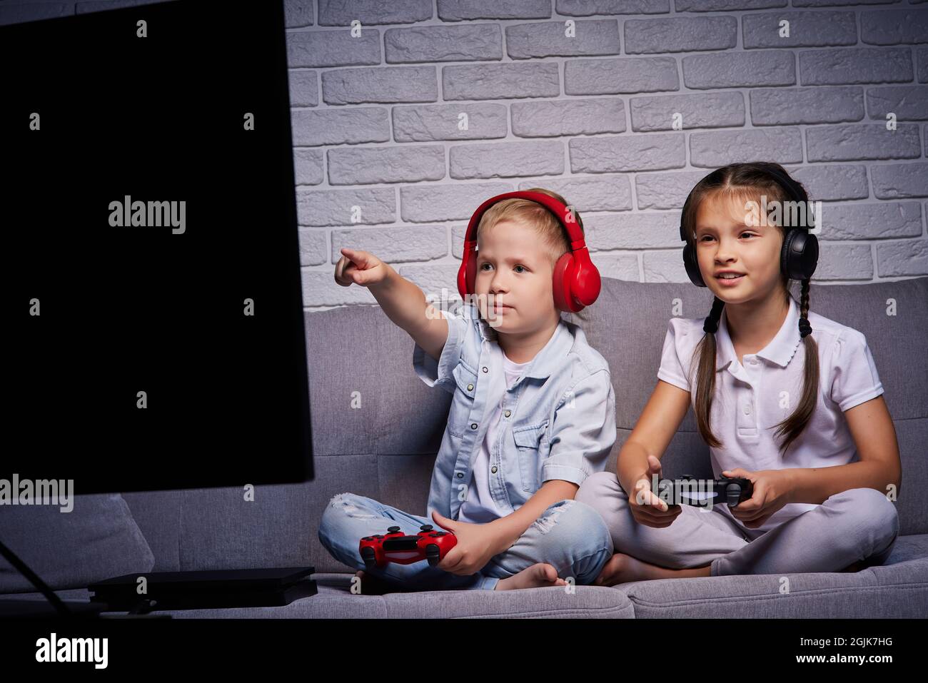 children playing video game with game console Stock Photo - Alamy