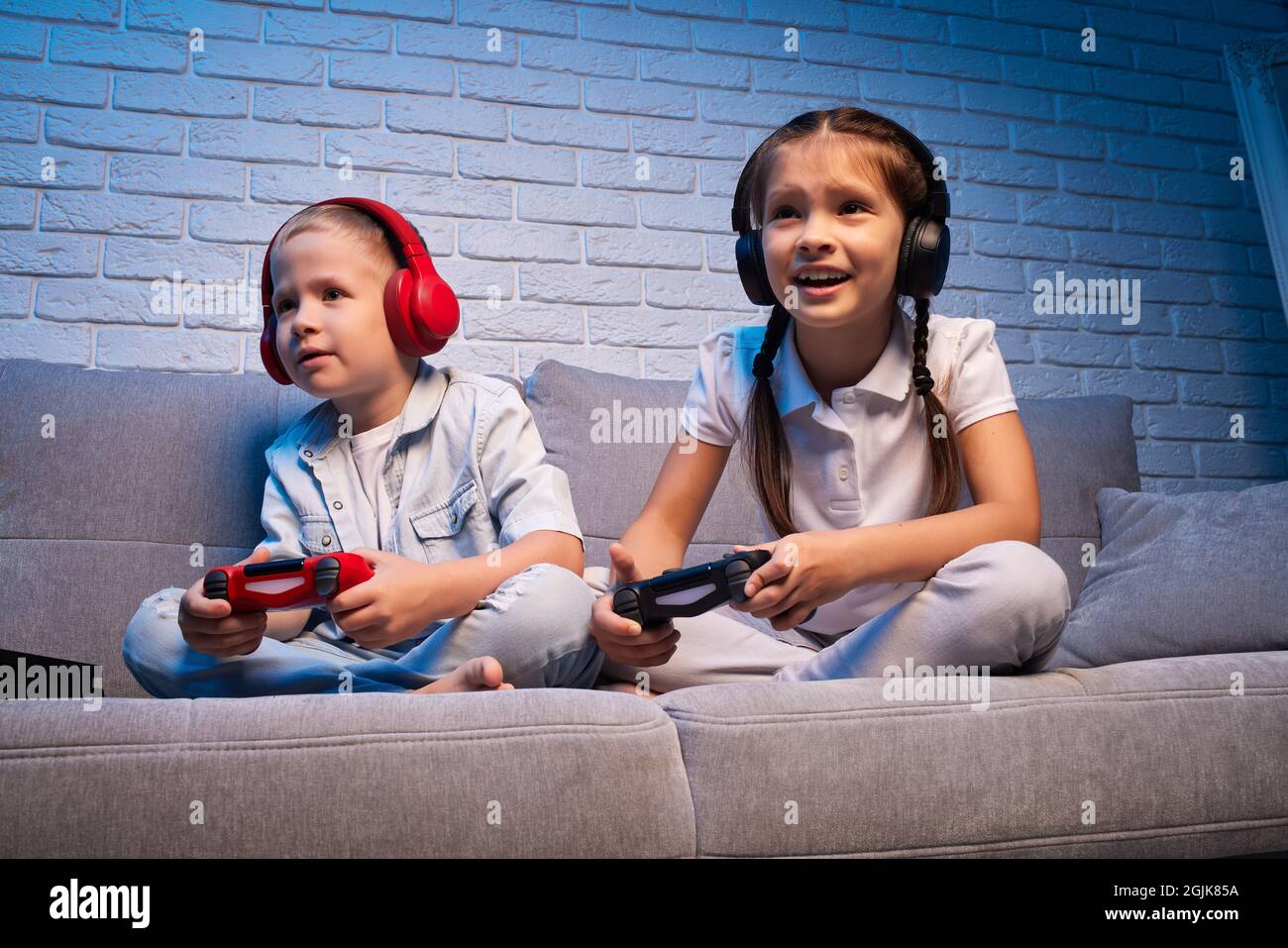 children playing video game with game console Stock Photo - Alamy