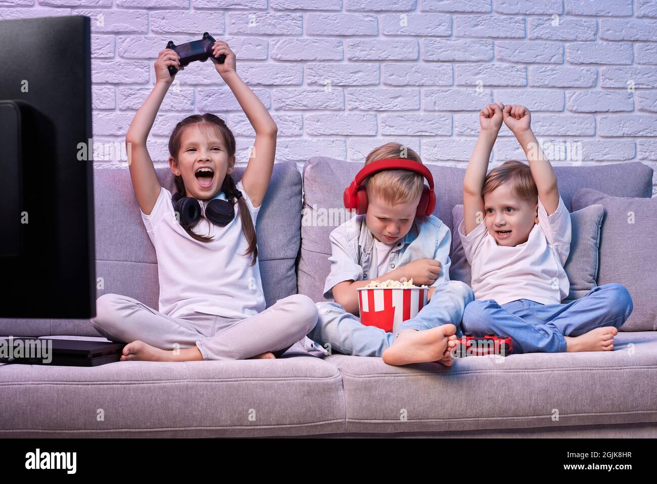 children playing video game with game console Stock Photo - Alamy