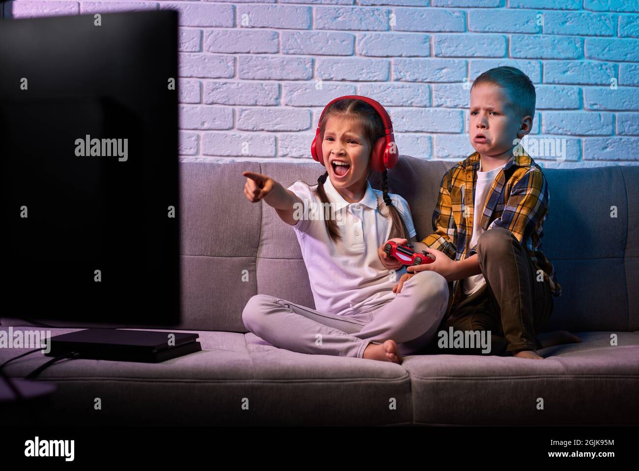 children playing video game with game console Stock Photo - Alamy
