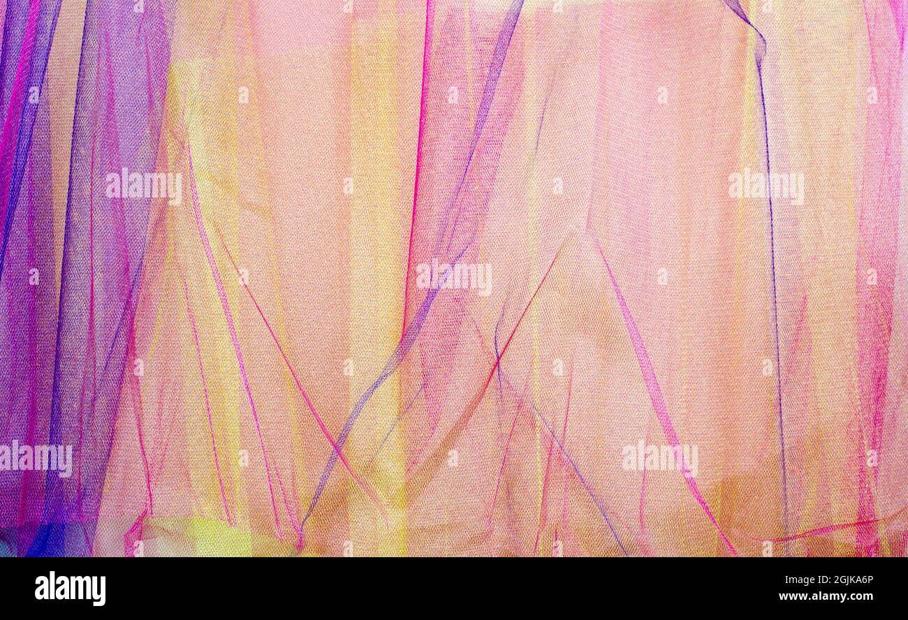 Background from multi-colored tulle. Purple and pink tulle on a yellow ...