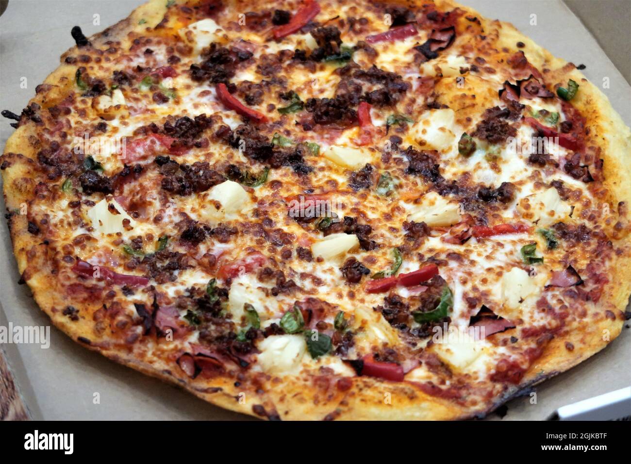 Delicious pizza with lots of cheese and ingredients being cooked in the ...