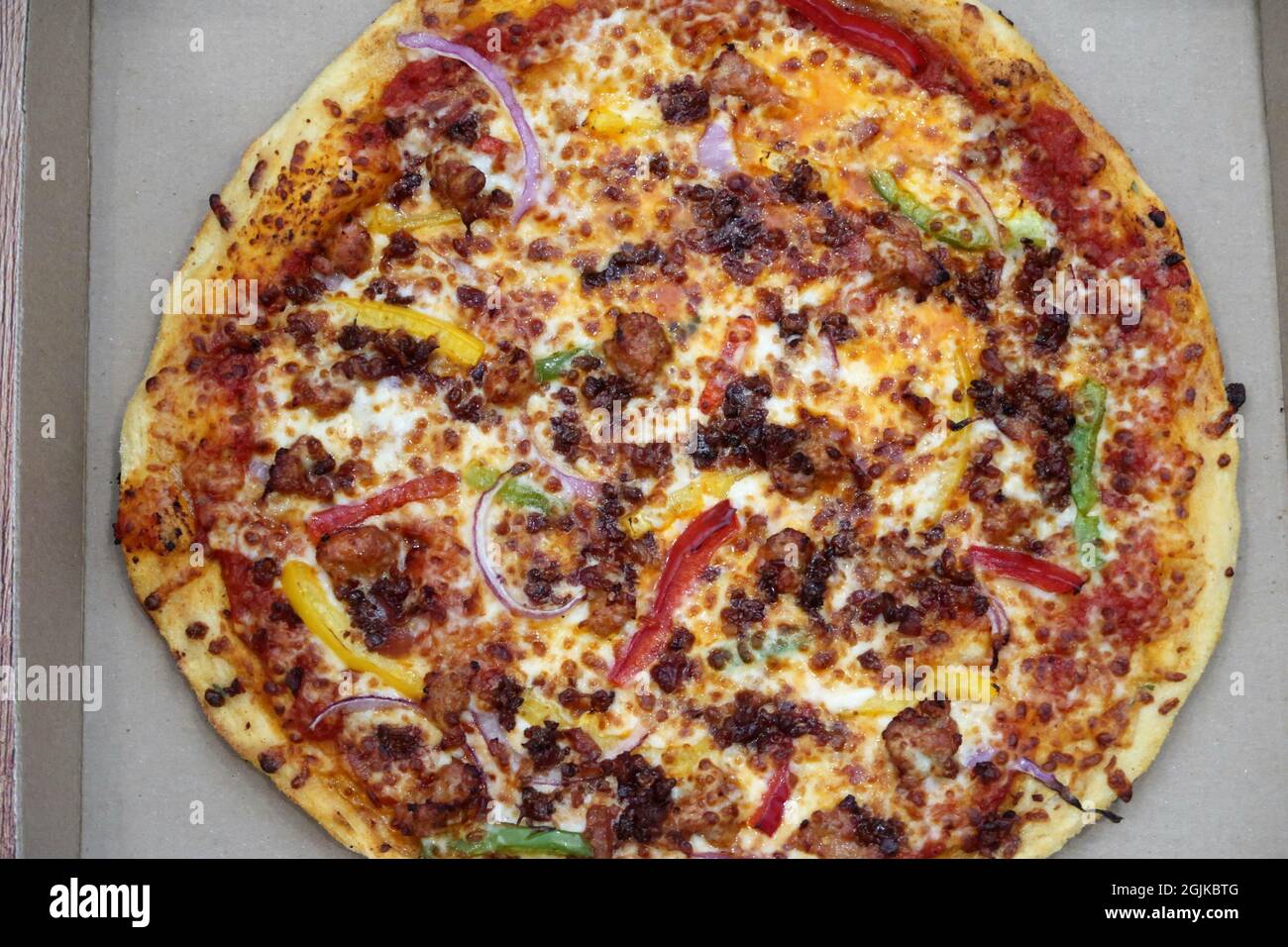 Delicious pizza with lots of cheese and ingredients being cooked in the ...