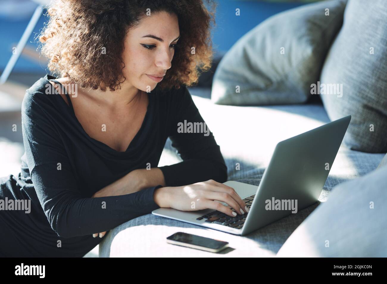 Young businesswoman remote working at home using her laptop computer on ...