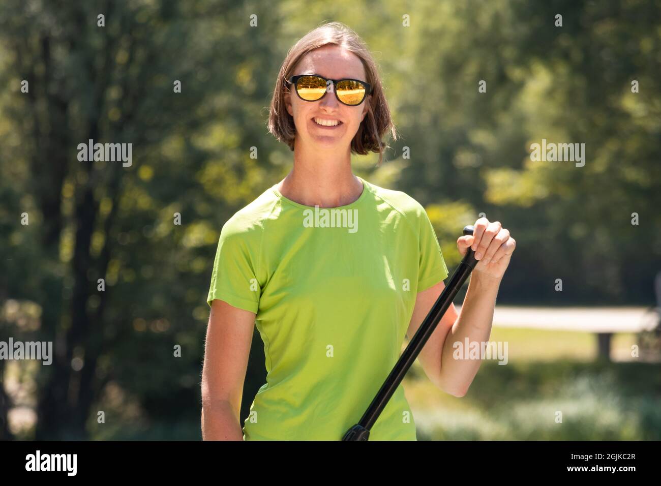 Smiling woman holding paddle hi-res stock photography and images - Alamy