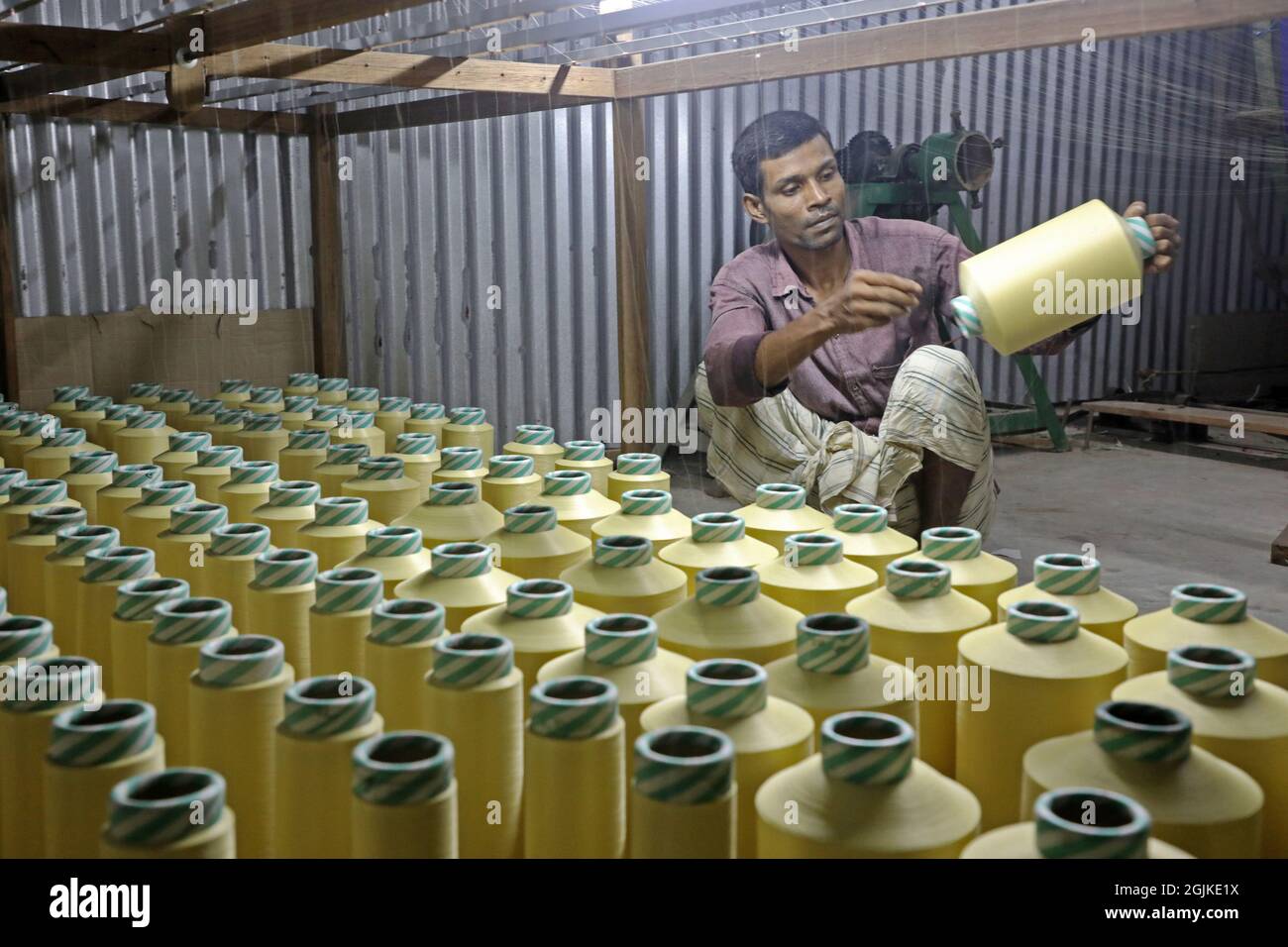 Non Exclusive: An employee during a process of yarns production before ...