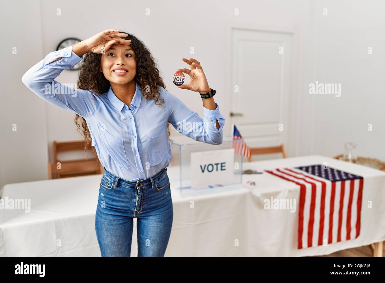 Beautiful hispanic woman standing by at political campaign by voting ...