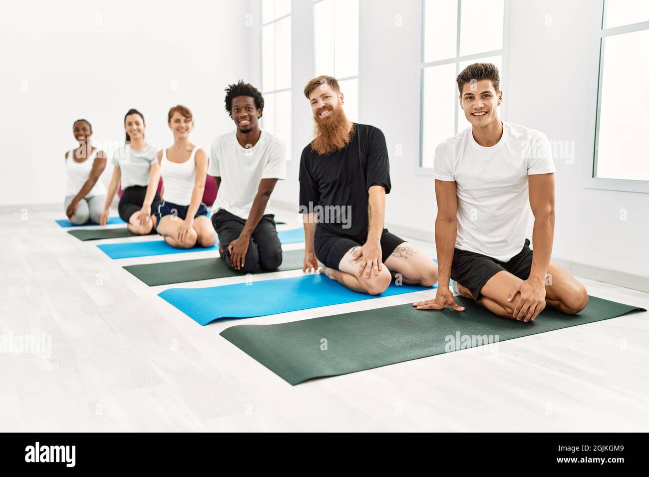Group of young people smiling happy stretching at sport center Stock ...