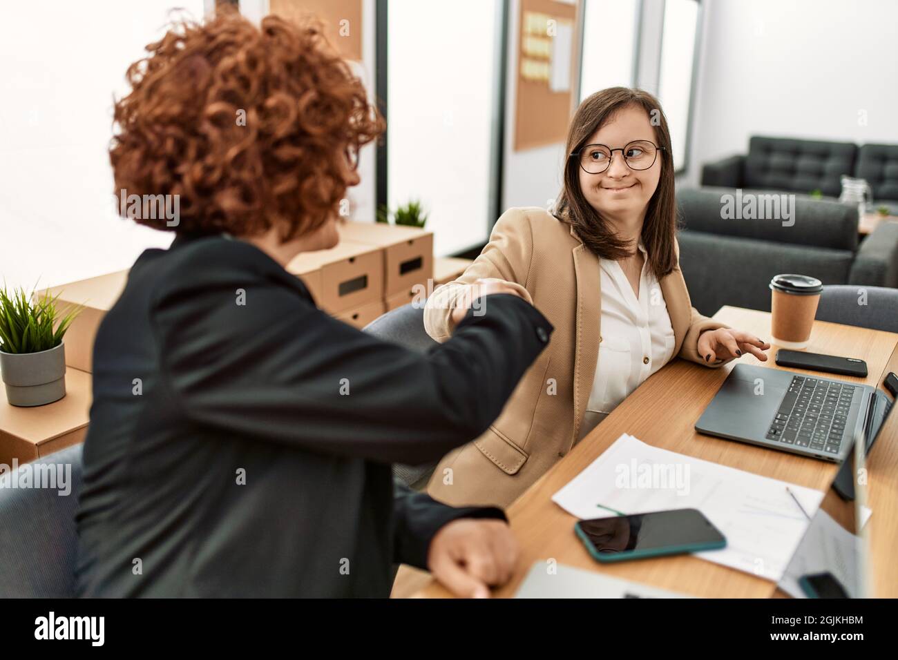Group of two women working at the office. Mature woman and down ...