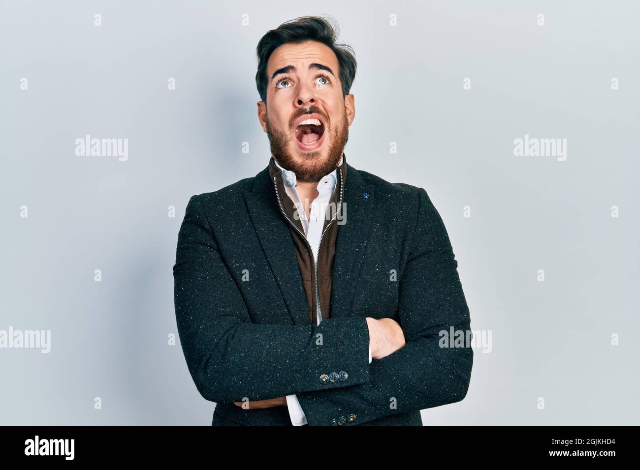 Handsome caucasian man with beard with arms crossed gesture angry and ...