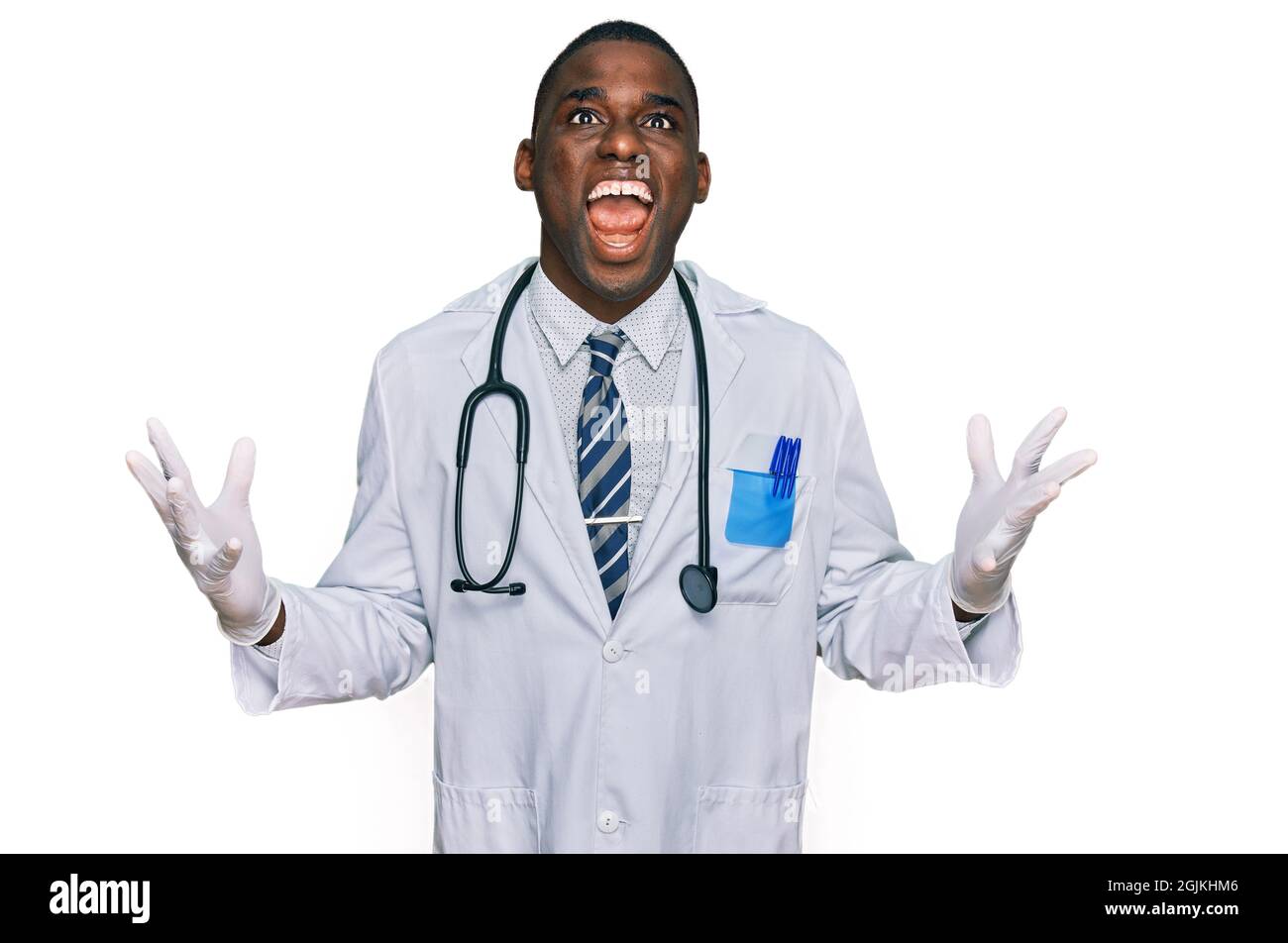 Young african american man wearing doctor uniform and stethoscope crazy ...